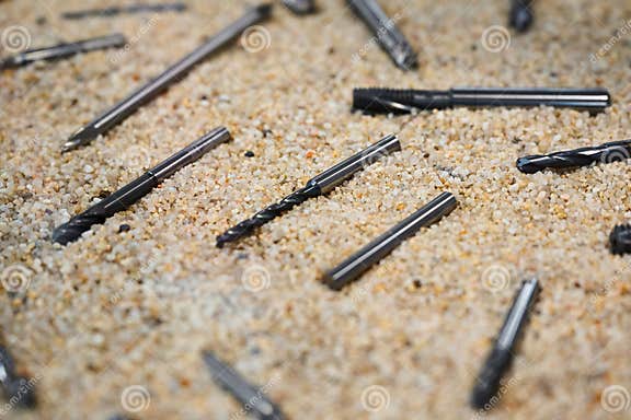 Different Drilling Tools on Sand Surface in Workshop Stock Photo ...
