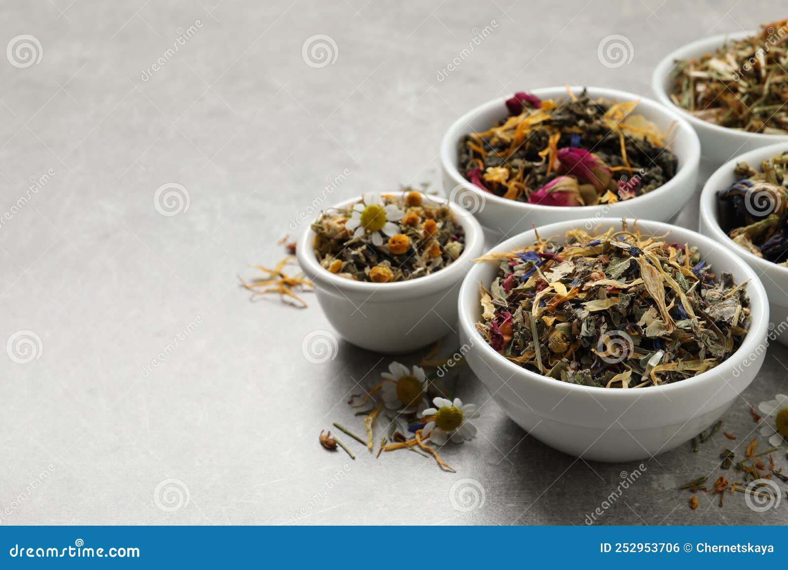 Different Dry Aromatic Teas on Light Grey Table, Space for Text Stock ...