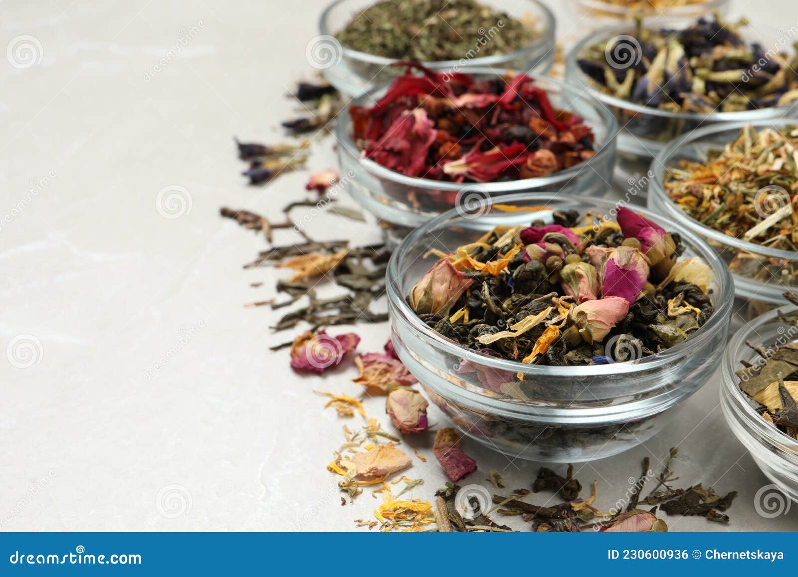 Different Dry Aromatic Teas on Light Table, Space for Text Stock Photo ...