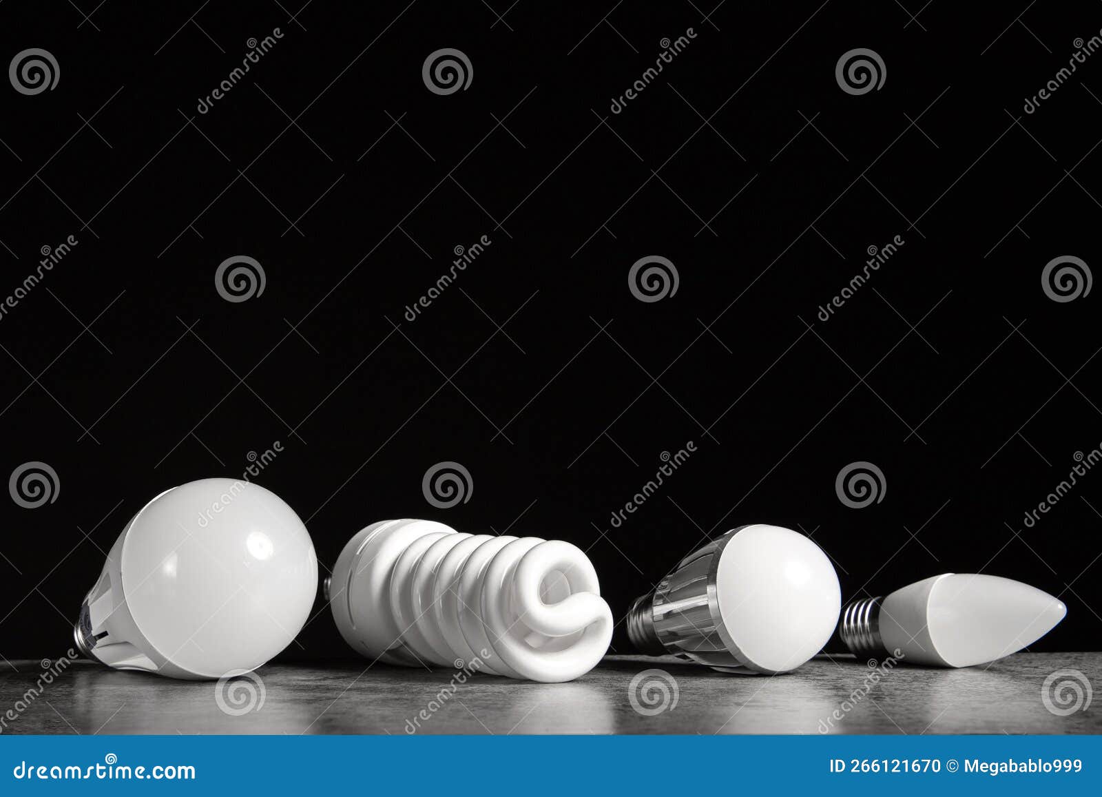 4 Different E27 Household Light Bulbs on a Black Background with Copy ...