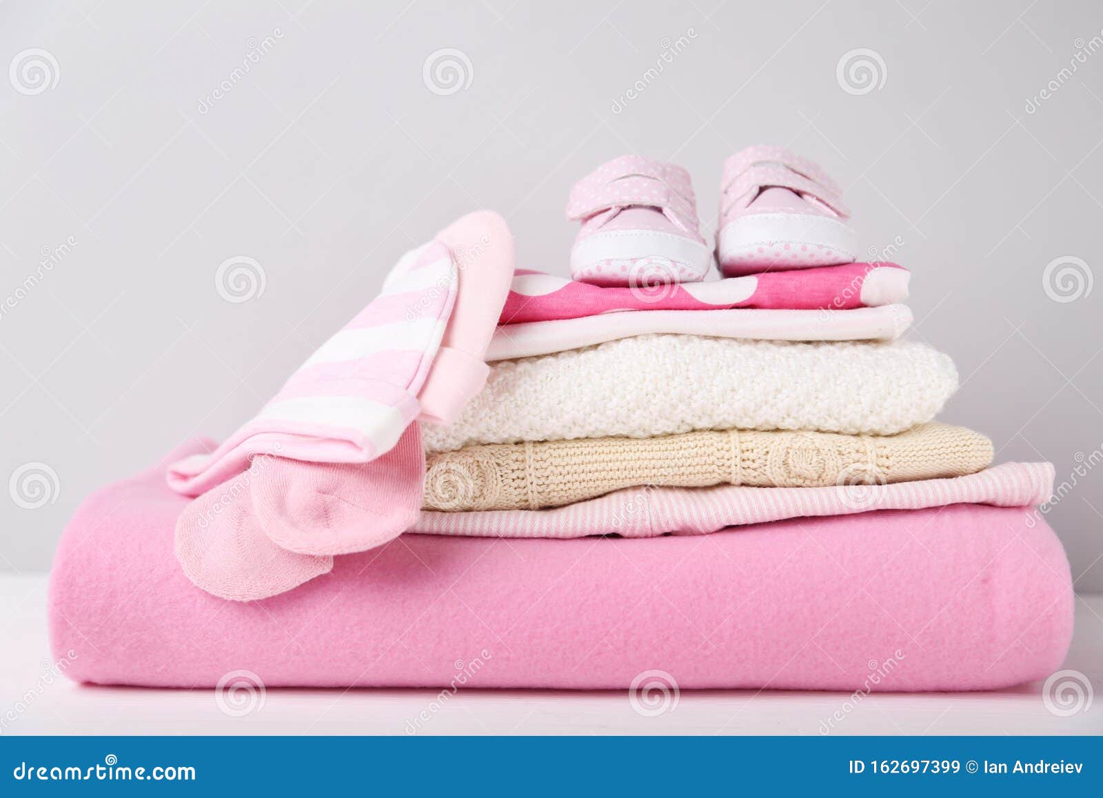 Folded Baby Clothes With Soft Bear Toy Stock Image | CartoonDealer.com ...