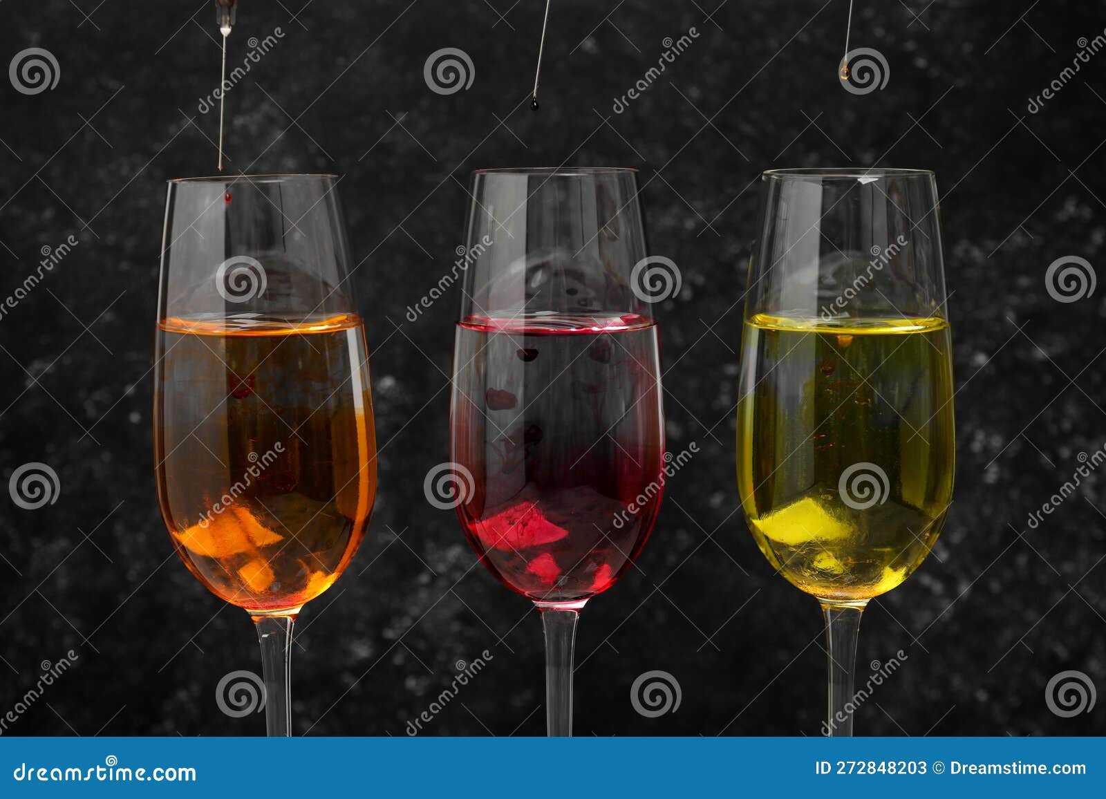 Different Food Coloring Pouring into Glasses on Grey Background Stock ...