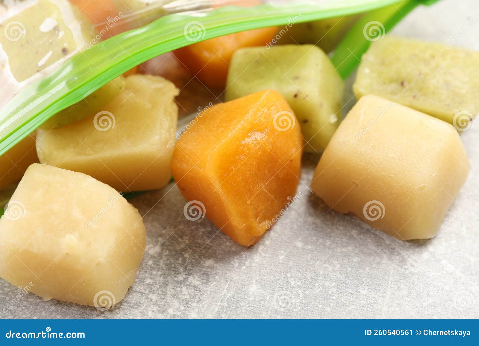 Different Frozen Fruit Puree Cubes in Plastic Bag on Table, Closeup ...