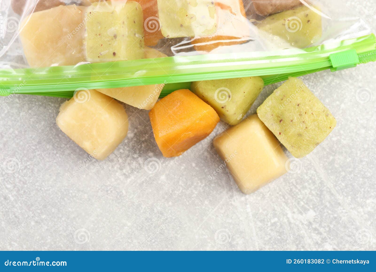 Different Frozen Fruit Puree Cubes in Plastic Bag on Table, Flat Lay ...