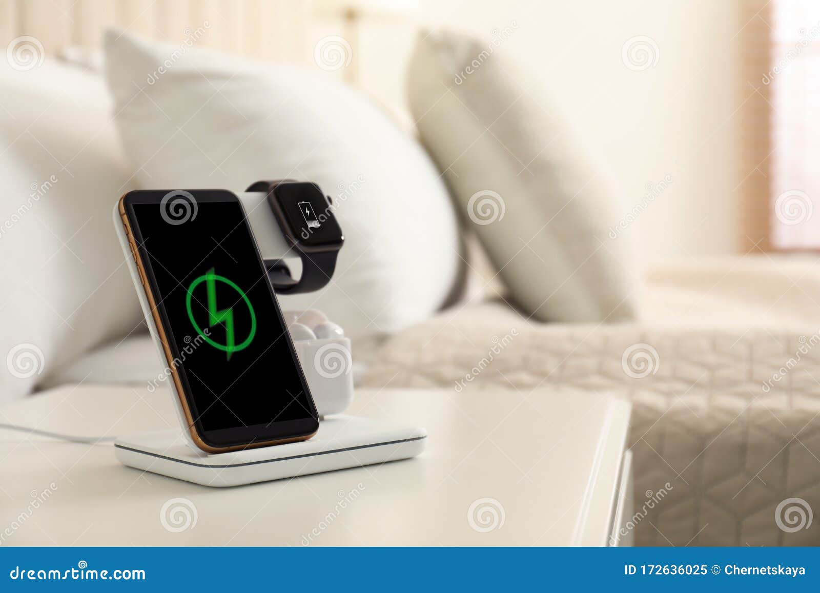 Different Gadgets Charging on Wireless Pad in Bedroom Stock Image ...