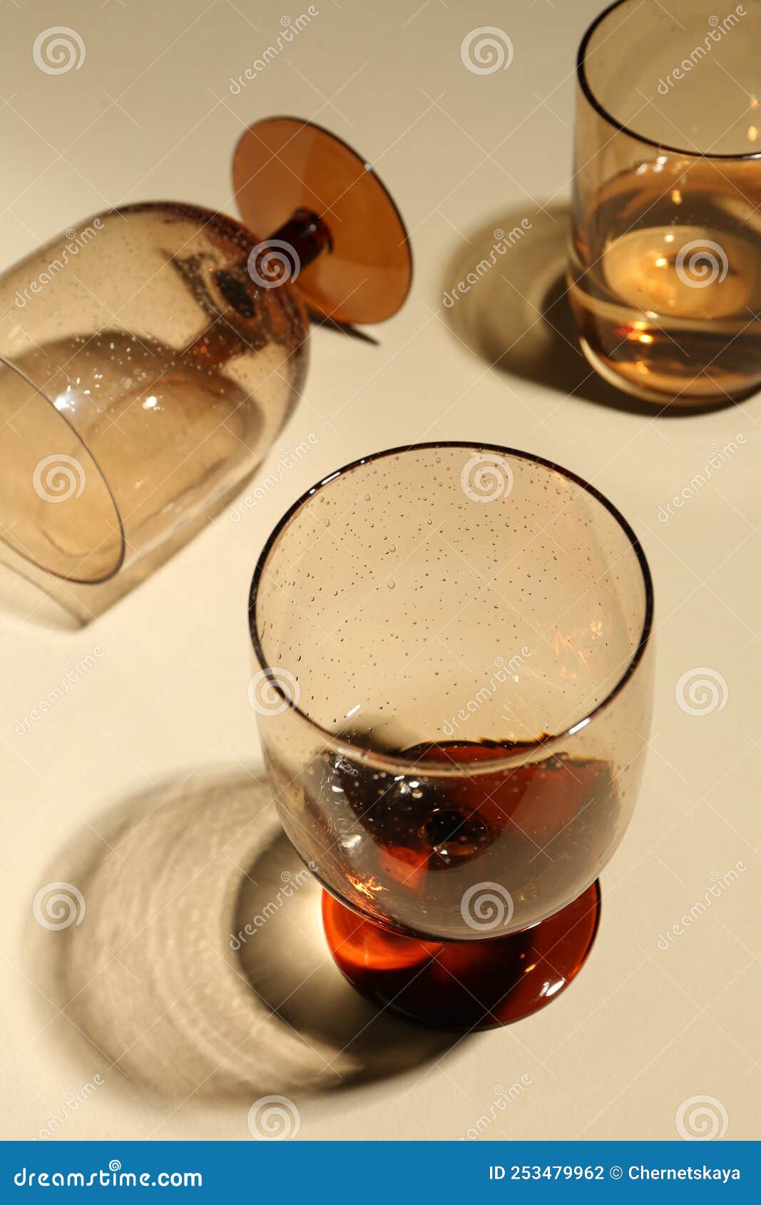 Different Glasses with Drinks on Beige Background Stock Photo - Image ...