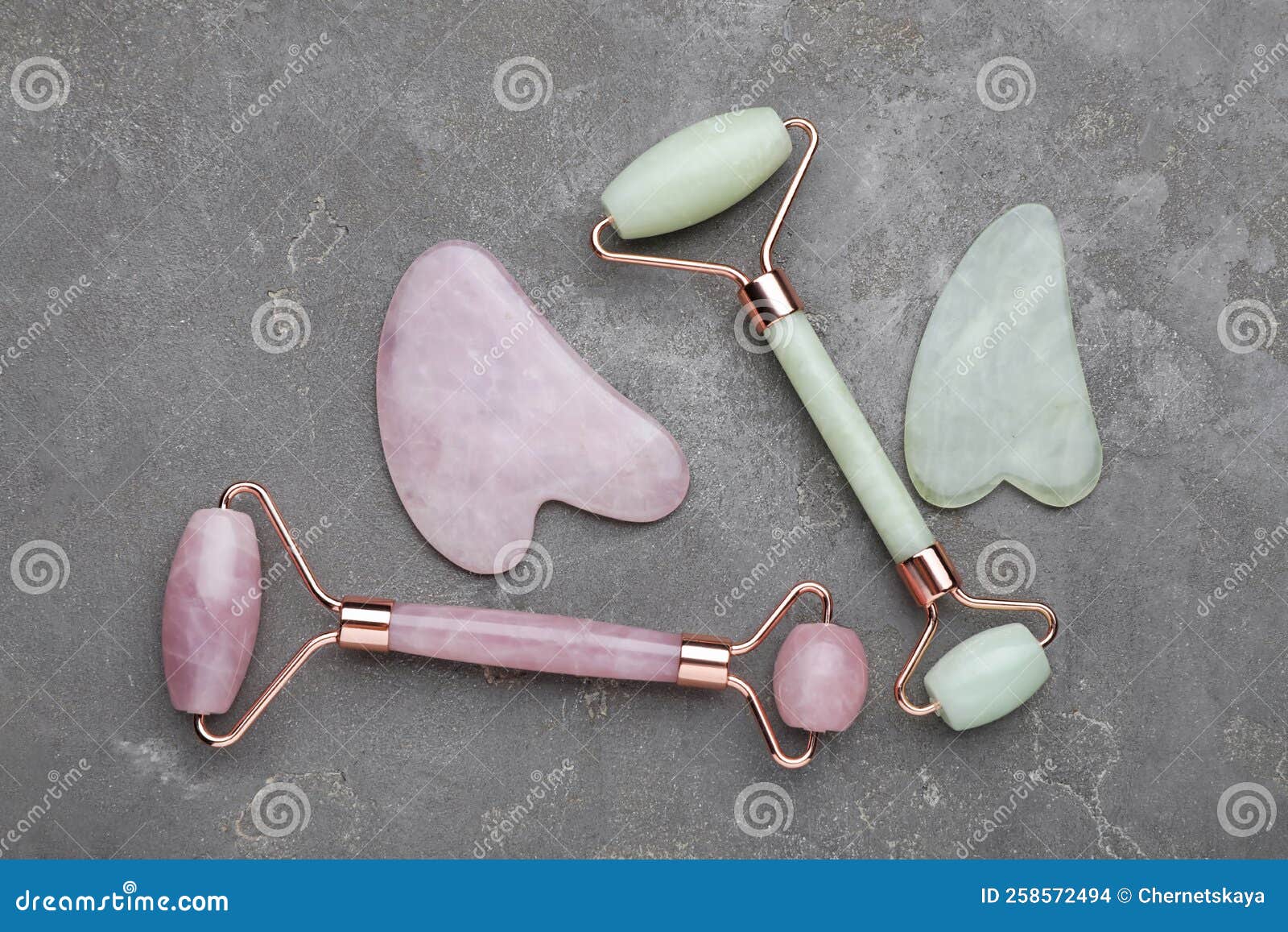Different Gua Sha Stones and Face Rollers on Grey Table, Flat Lay Stock ...