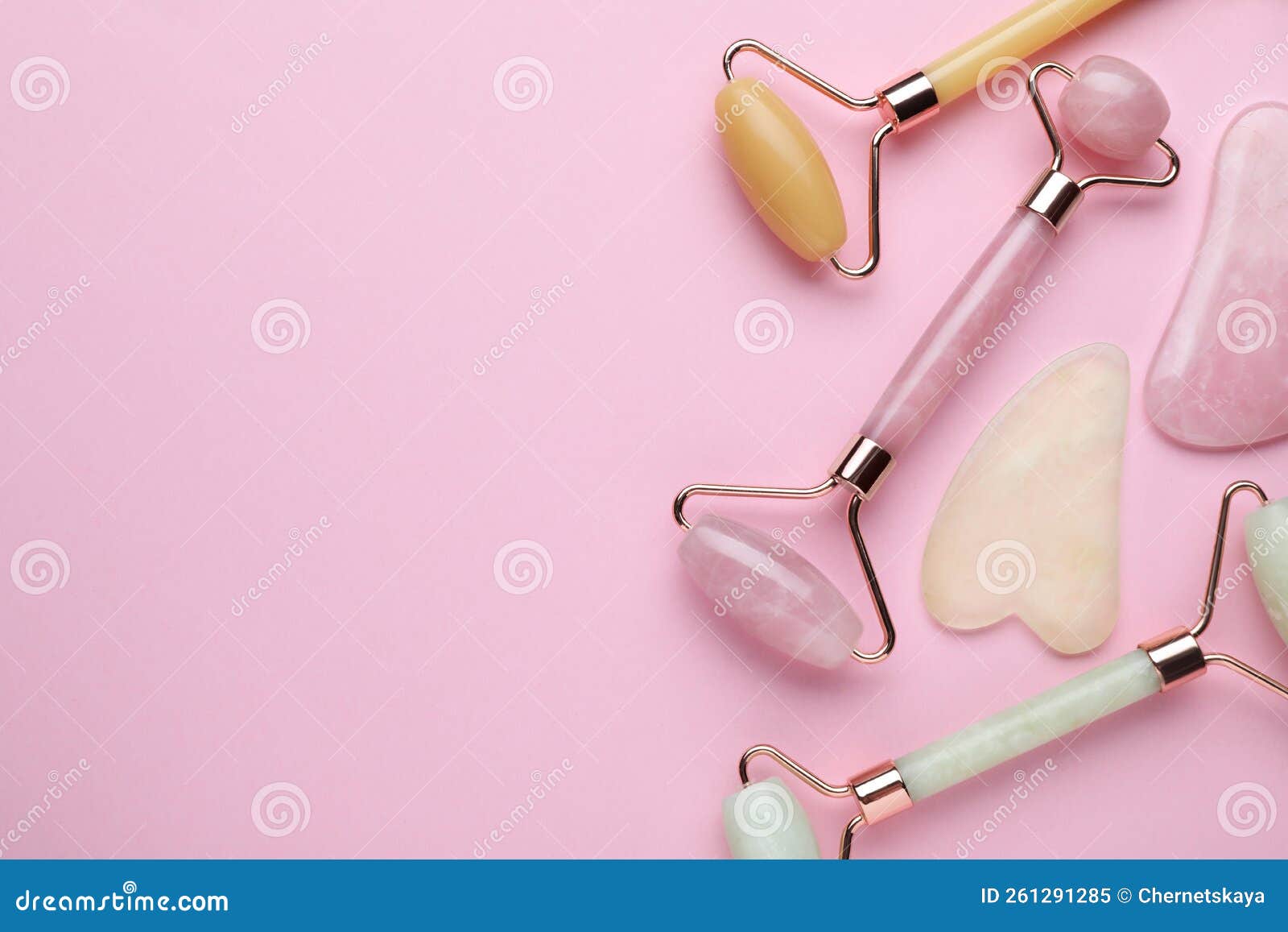 Different Gua Sha Stones and Face Rollers on Pink Background, Flat Lay ...