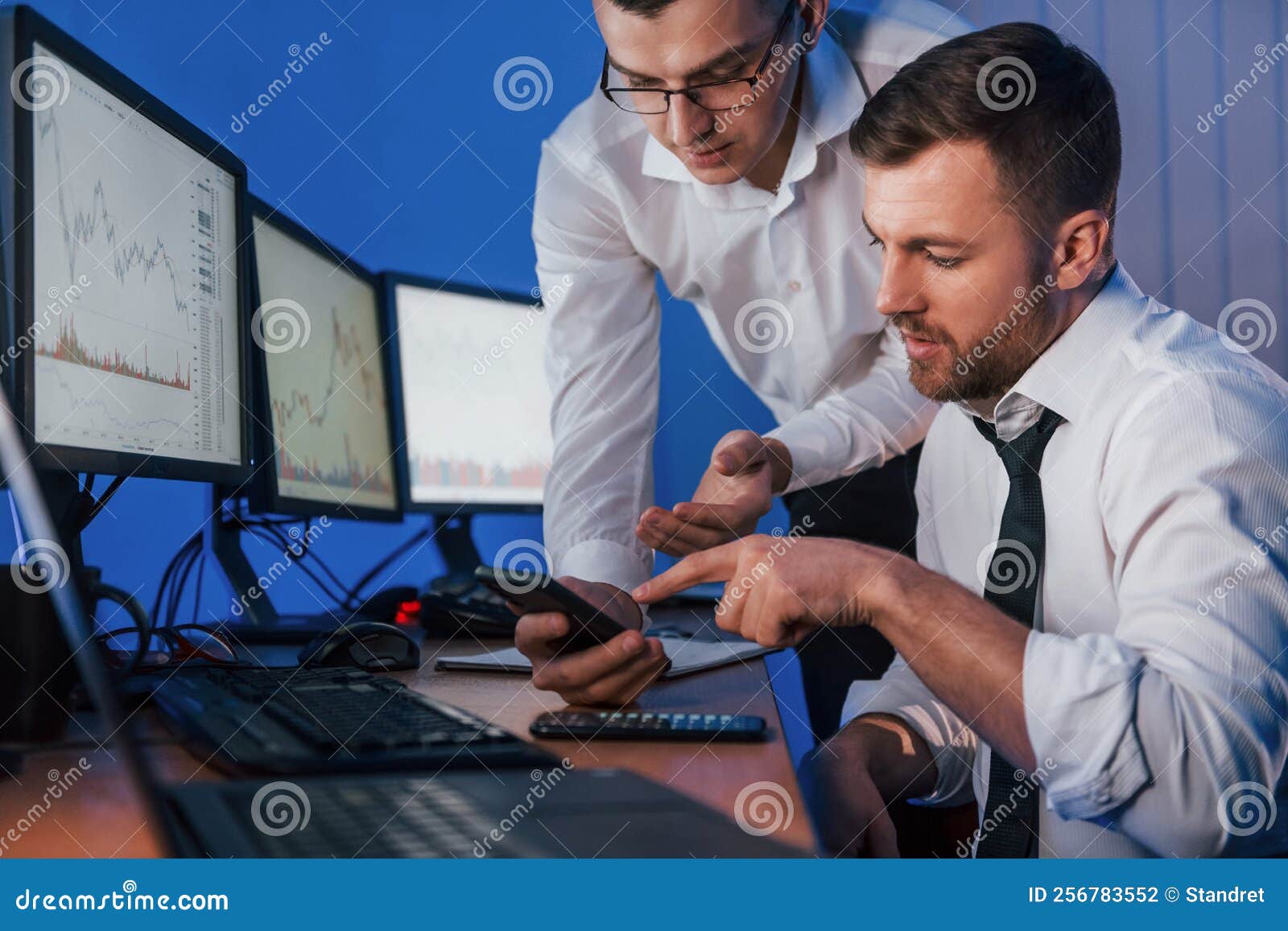 Different Information on Screens. Two Stock Traders Working in the ...