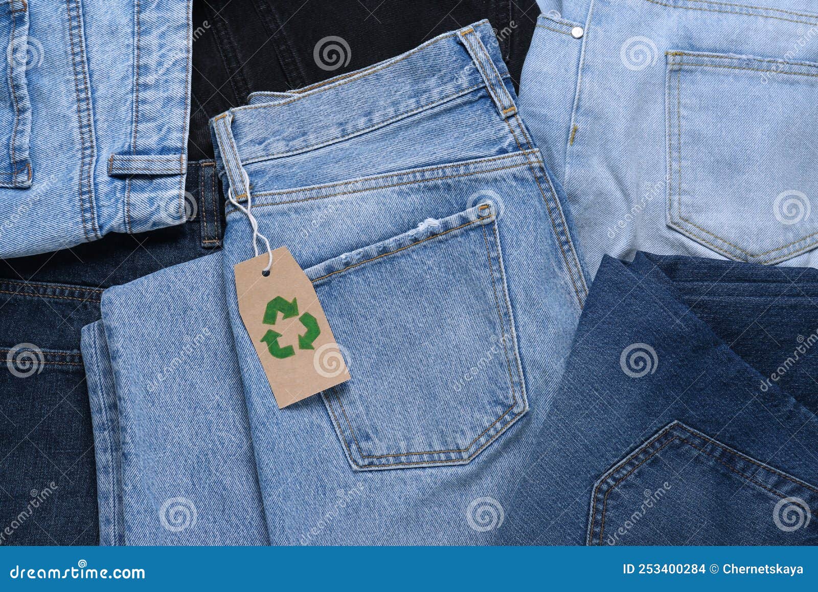 Different Jeans with Recycling Label As Background, Top View Stock ...