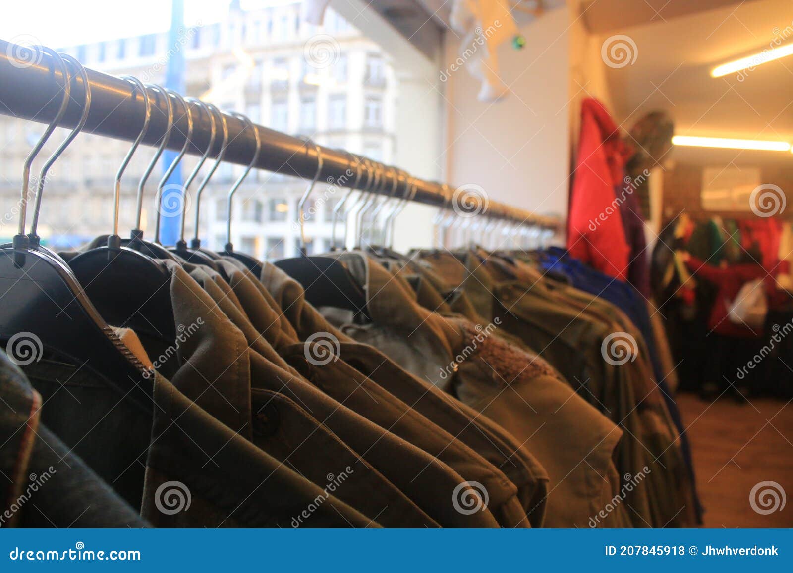 Different Jumpers, Jackets Etc. Handing in a Second Hand Clothing Store ...