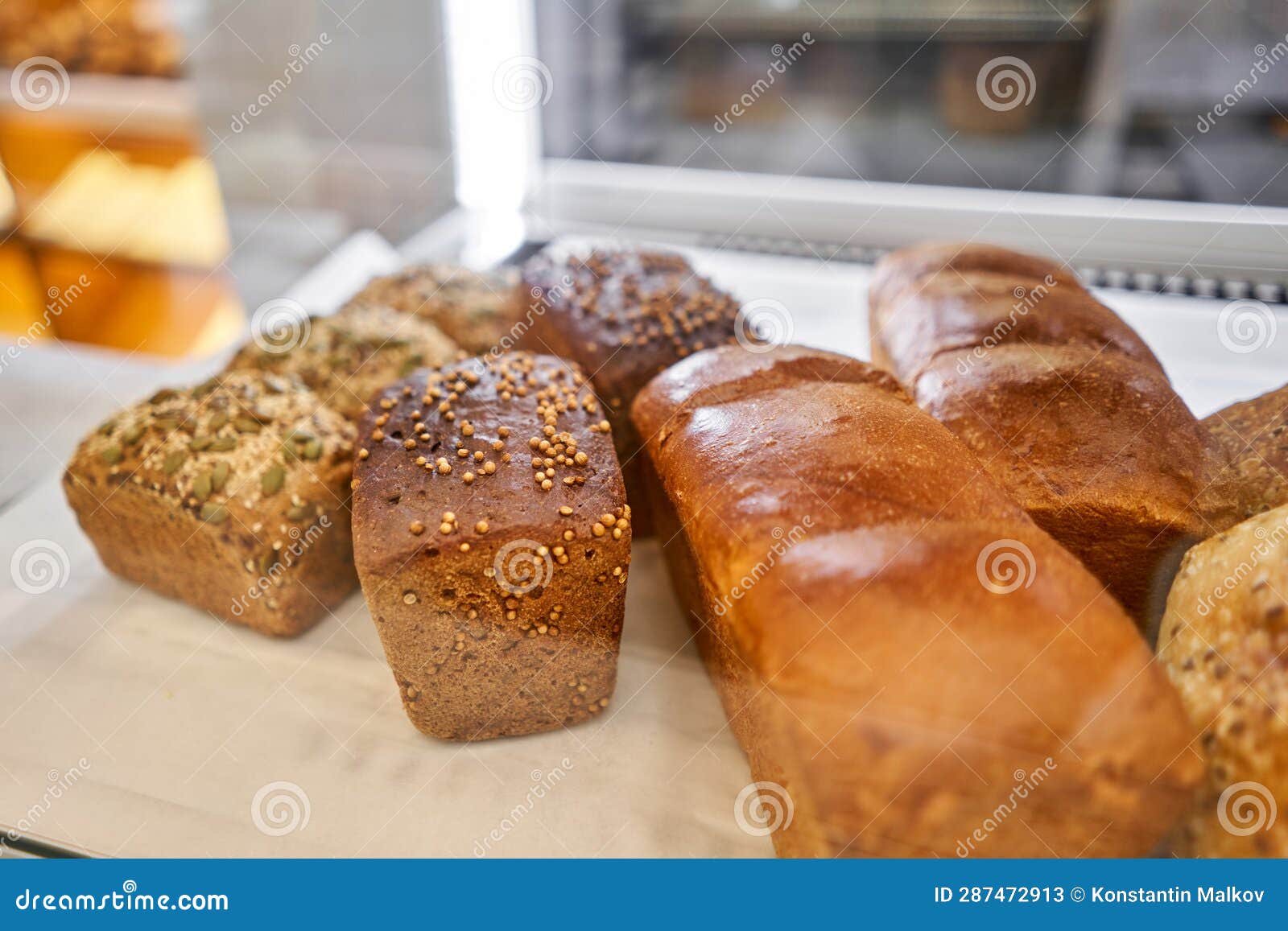 Different Kinds of Bread on the Counter in the Bakery Shop. Fresh Bread ...