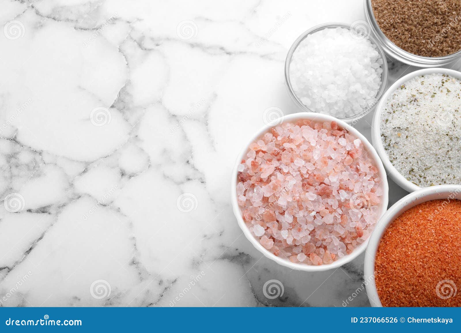 Different Kinds of Salt on White Marble Table, Flat Lay. Space for Text ...