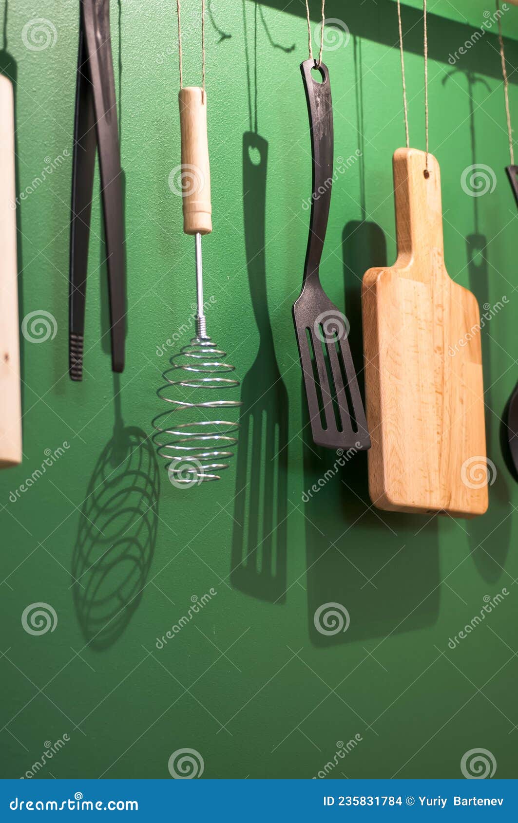 Different Kitchen Tools for Cooking Hanging on the Wall. Stock Photo ...