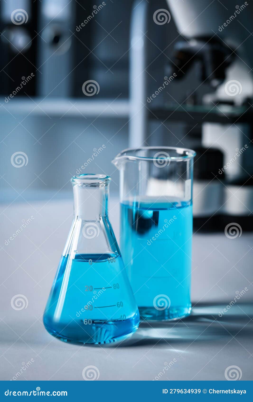 Different Laboratory Glassware with Light Blue Liquid on Table Stock ...