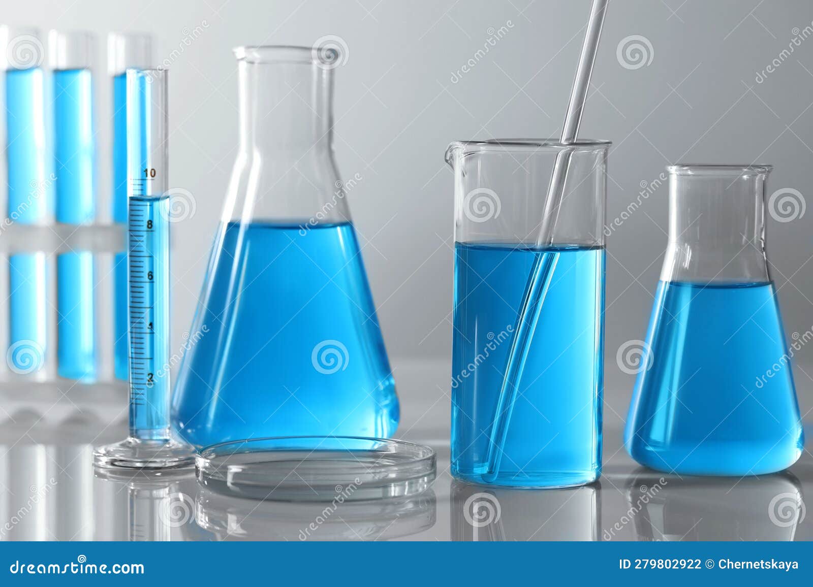 Different Laboratory Glassware and Test Tubes with Light Blue Liquid on ...