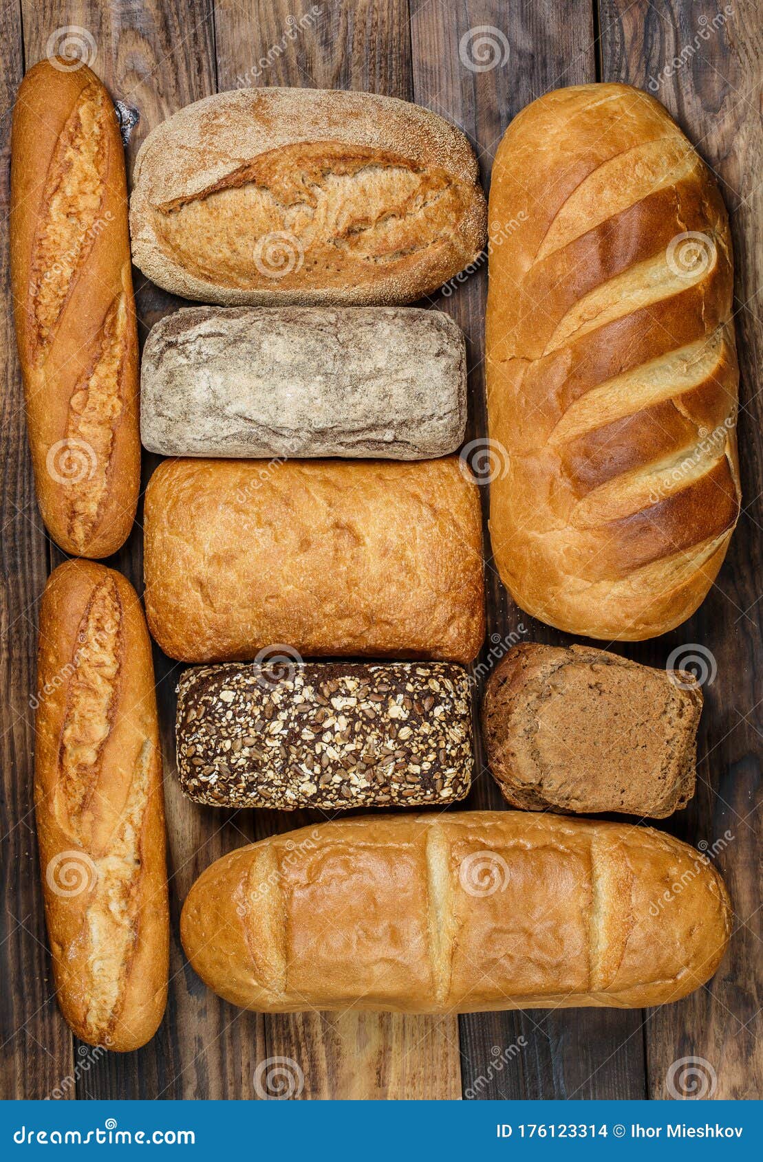 Different Loaves of Bread and Rolls with Wheat and Flour on a Wooden ...