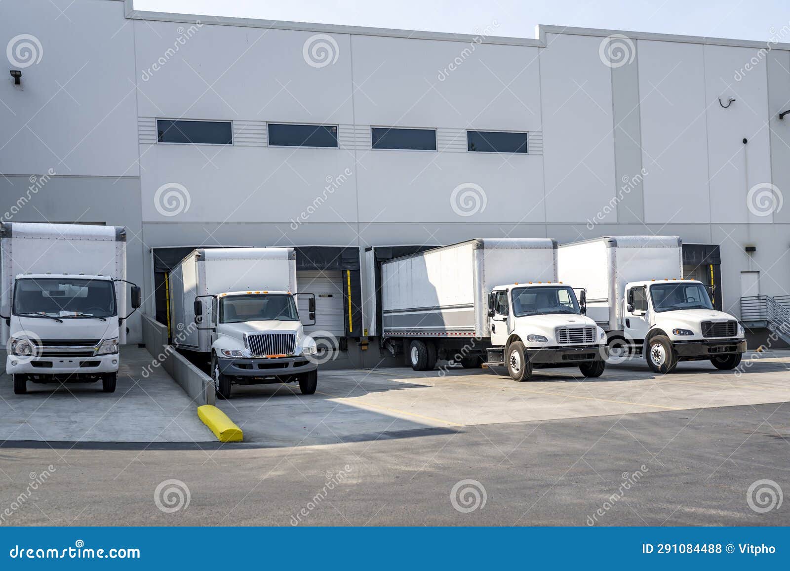 Middle Duty Rigs Semi Trucks With Box Trailers Standing In Warehouse ...