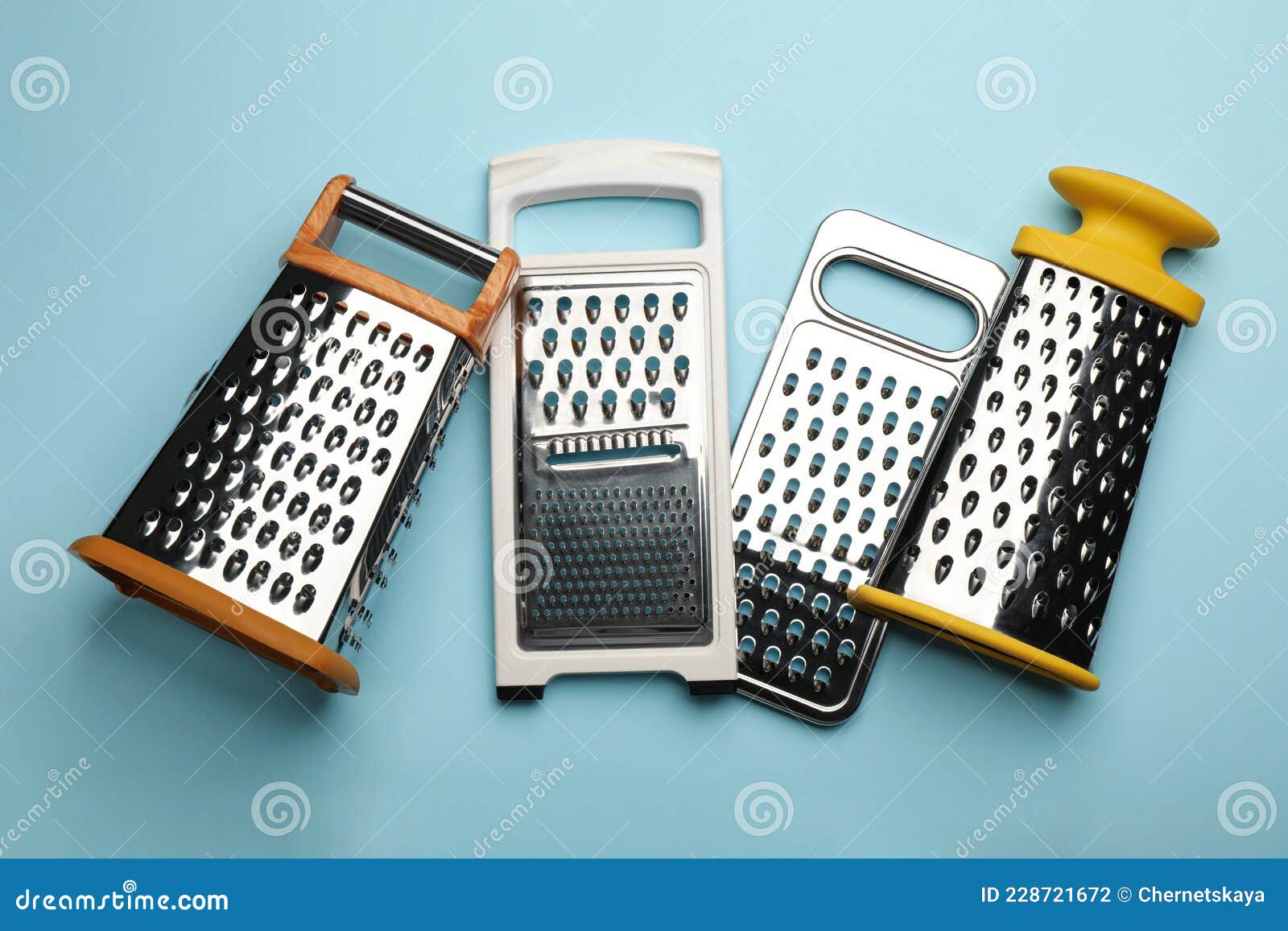 Different Modern Graters on Light Blue Background, Flat Lay Stock Photo ...