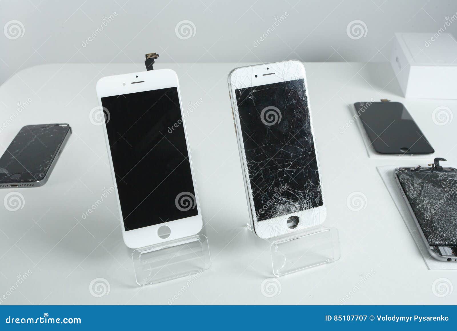 Different Modern Mobile Phones with Broken Screen on White Table Stock ...