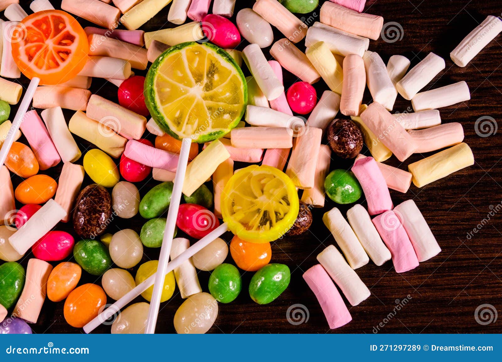 Different Multi Colored Candies on a Dark Wooden Table. Top View Stock ...