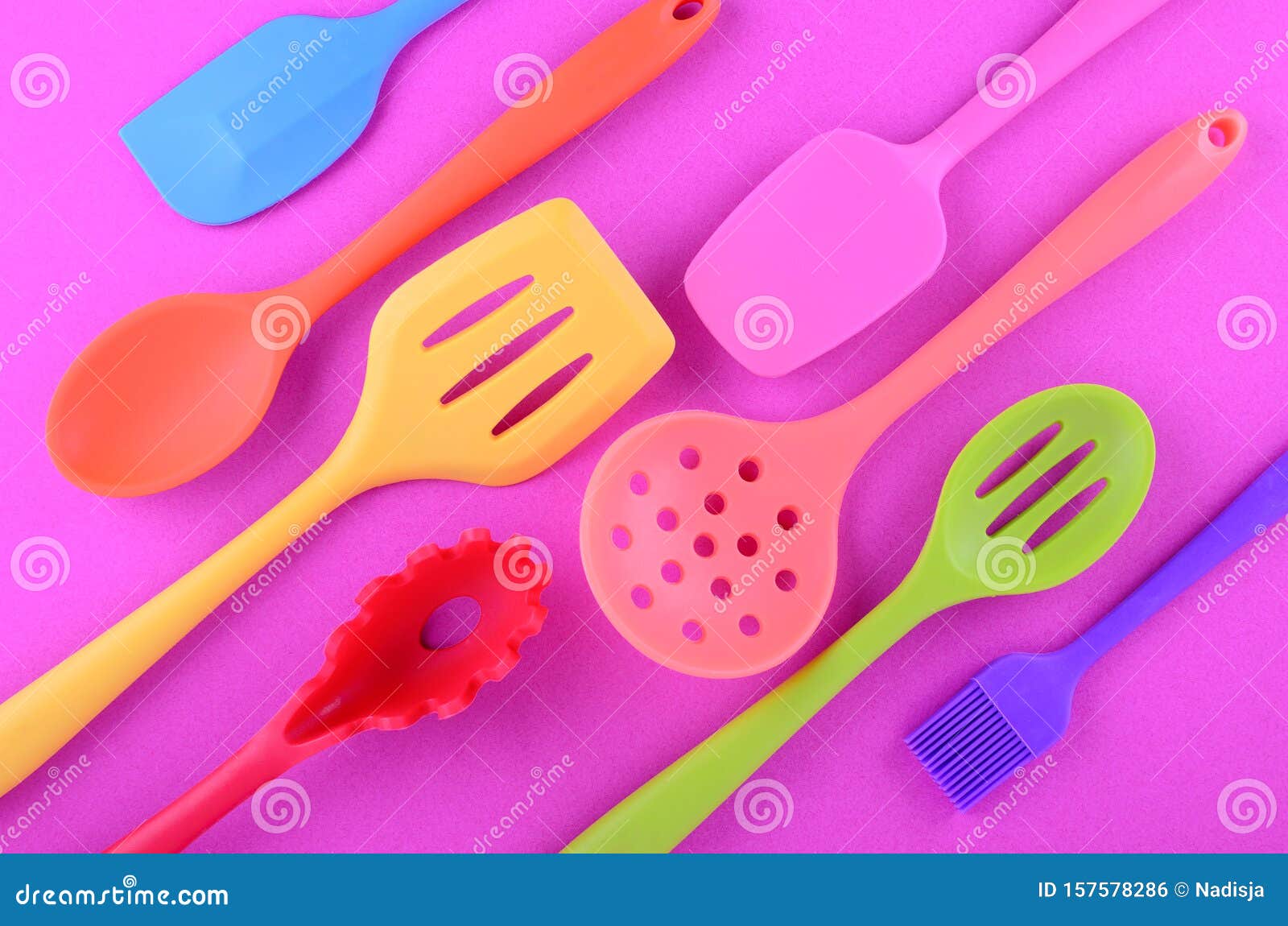 Bright Multi Colored Kitchen Utensils on Purple Background Stock Photo ...