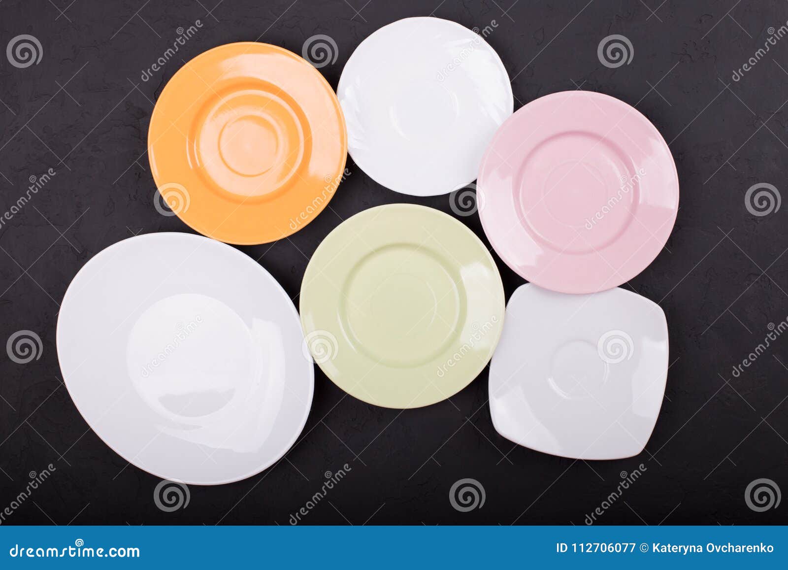 Different Multicolored Empty Plates on a Table, Set of Plates. T Stock ...