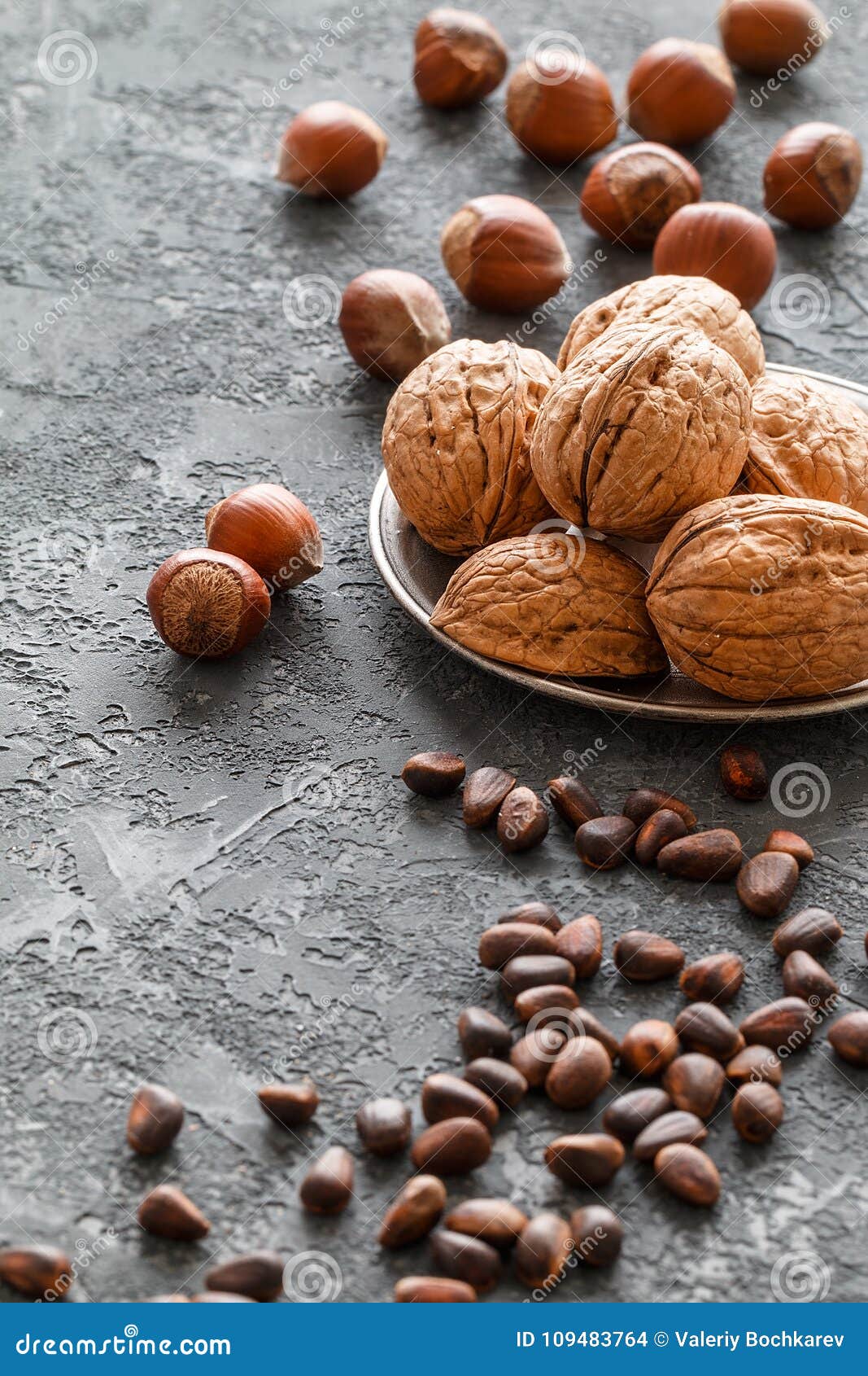 Different Nuts on Dark Stone Table. Hazelnut, Walnuts, Cedar Stock ...