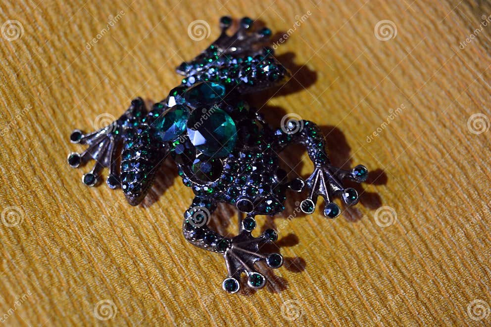 A Beautiful Female Jewelry, a Jewel with Green Stones, a Metal Frog, a ...