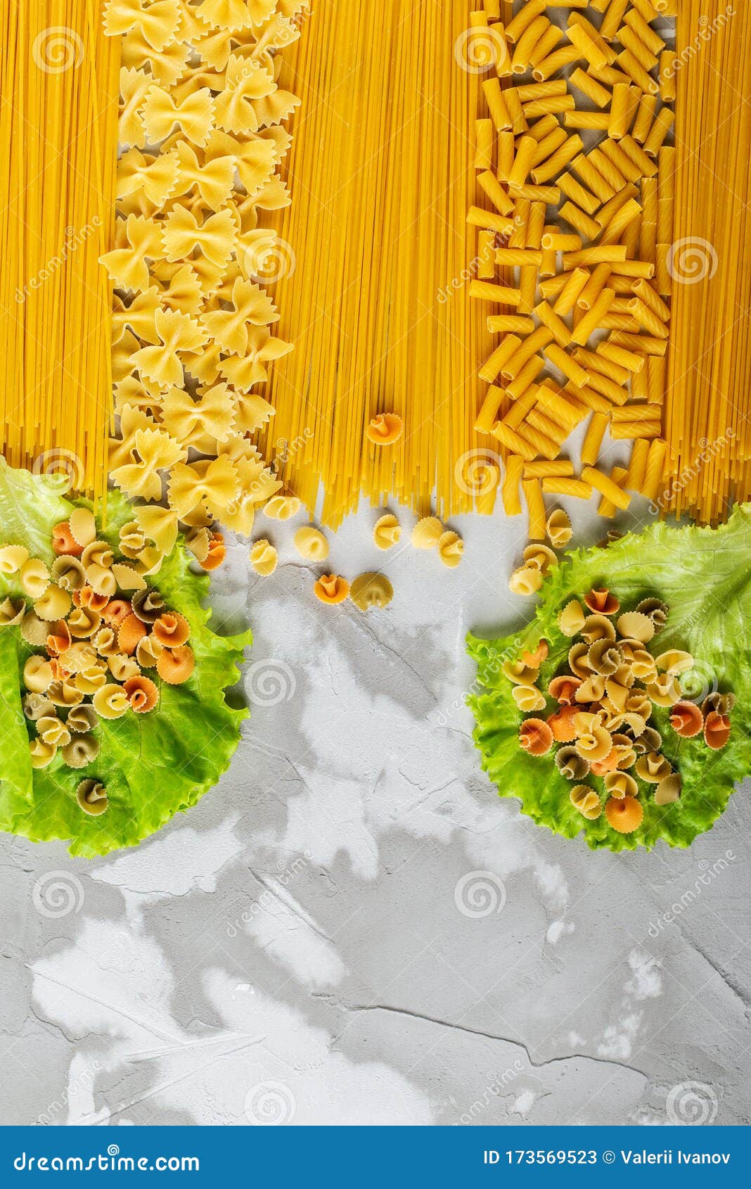 Different Pasta is Spread Out on Fresh Lettuce Leaves and Textured ...