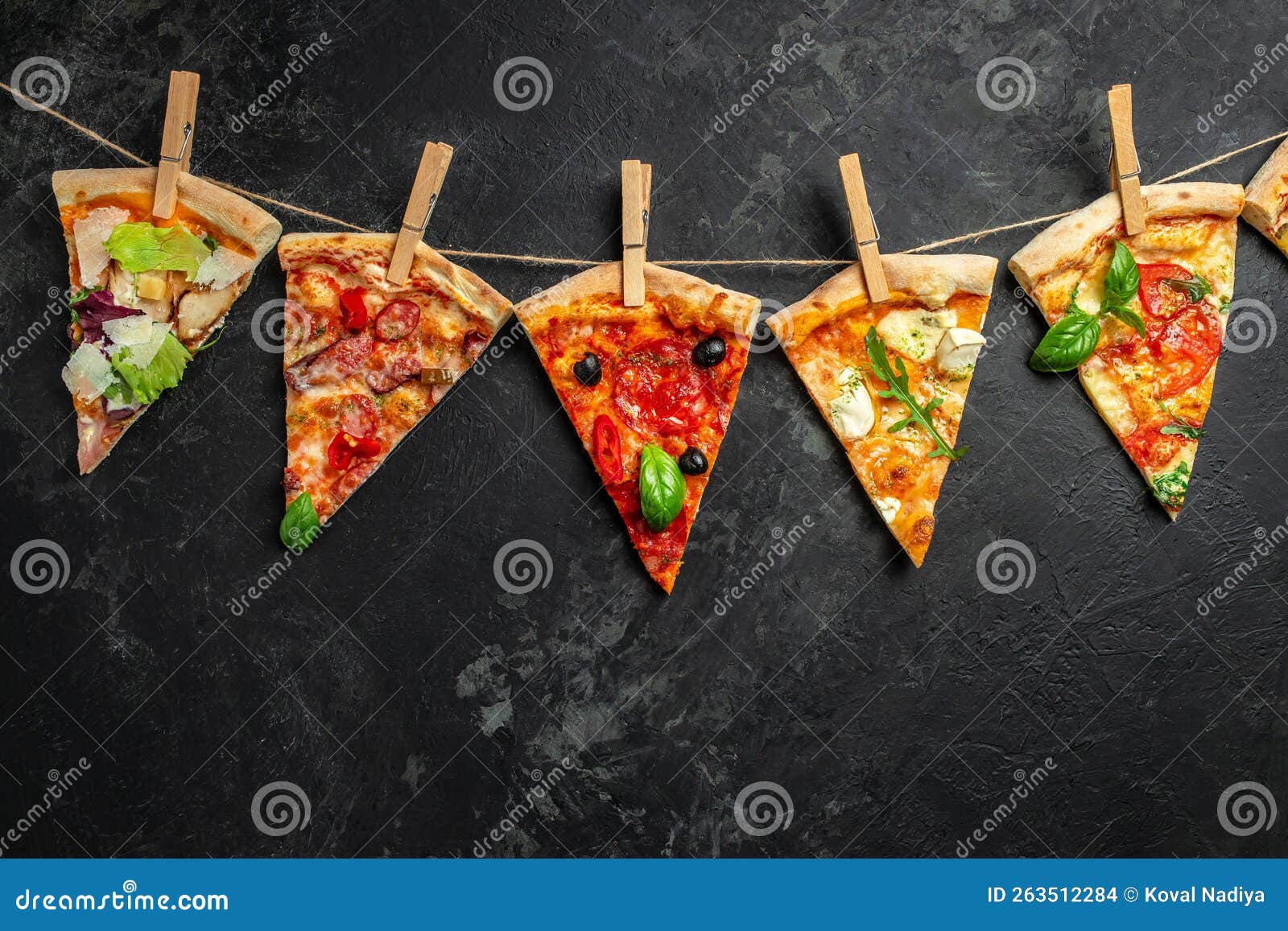 Different Pieces of Pizza on a String with Clothespins Dark Background ...
