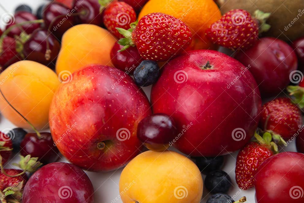 Different Ripe Fruits and Berries Lie in a Solid Layer on the White ...