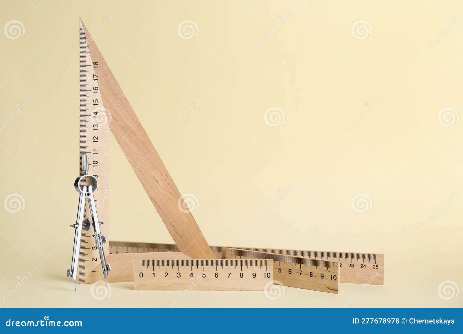 Different Rulers and Compass on Light Yellow Background Stock Photo ...
