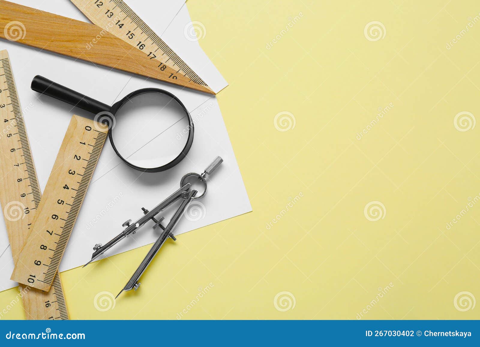 Different Rulers, Magnifying Glass and Compass on Yellow Background ...