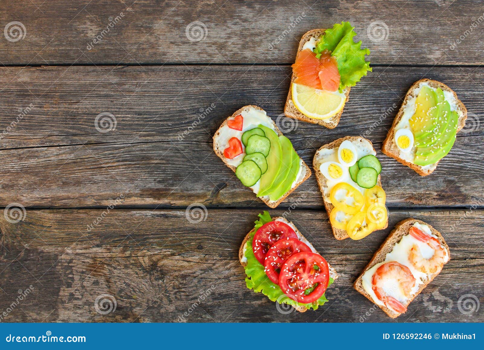 Of Different Sandwiches On The Old Wooden Background. Stock Photo ...