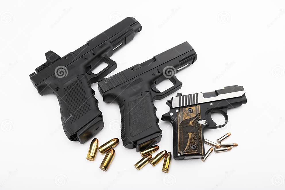 Different Size of Semi Automatic Hand Gun and Bullets on White ...