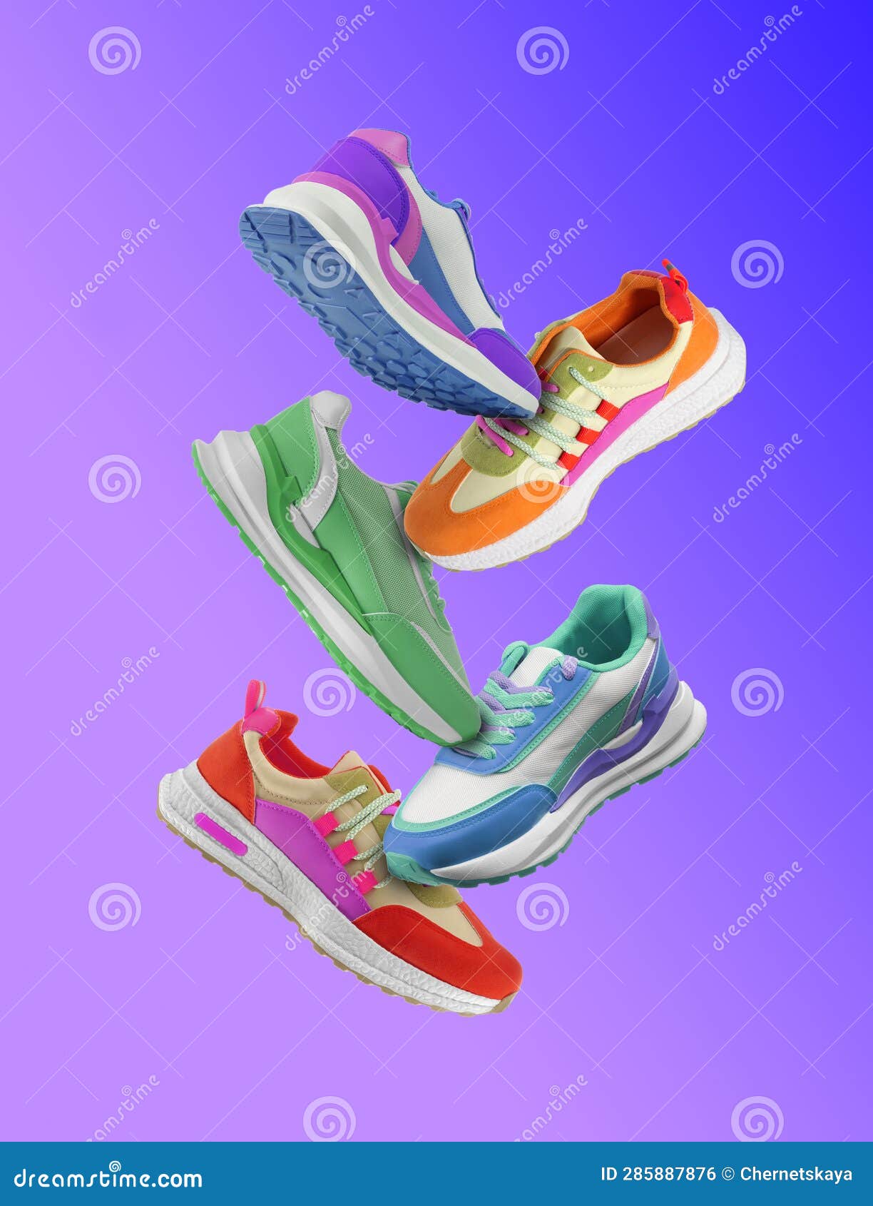Different Sneakers Falling on Blue Gradient Background Stock Photo ...