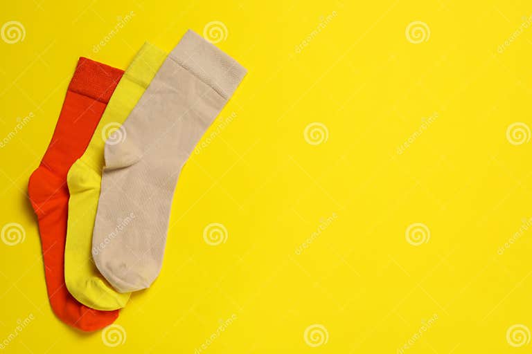 Different Socks on Yellow Background, Flat Lay. Space for Text Stock ...