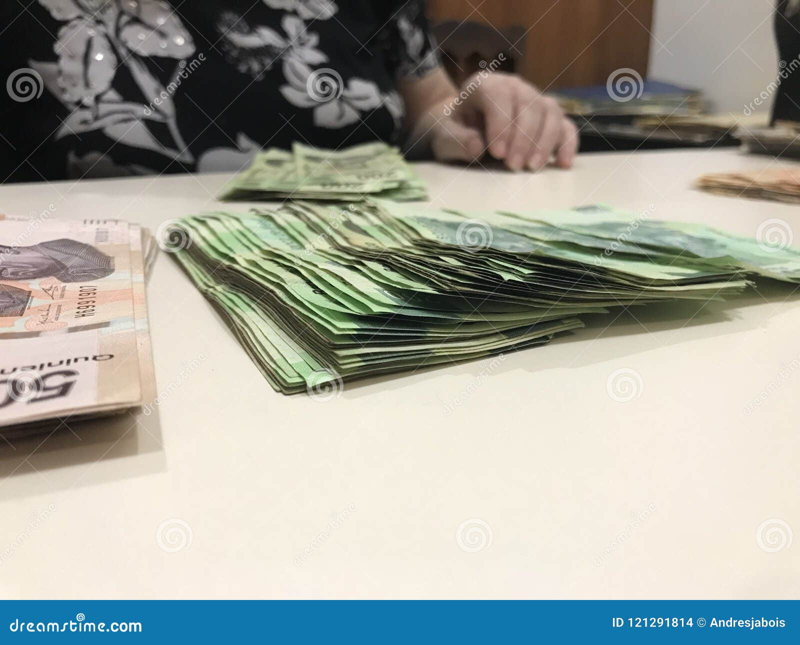 Stacked 200 and 500 Mexican Pesos on Top of a Beige Table Stock Photo ...