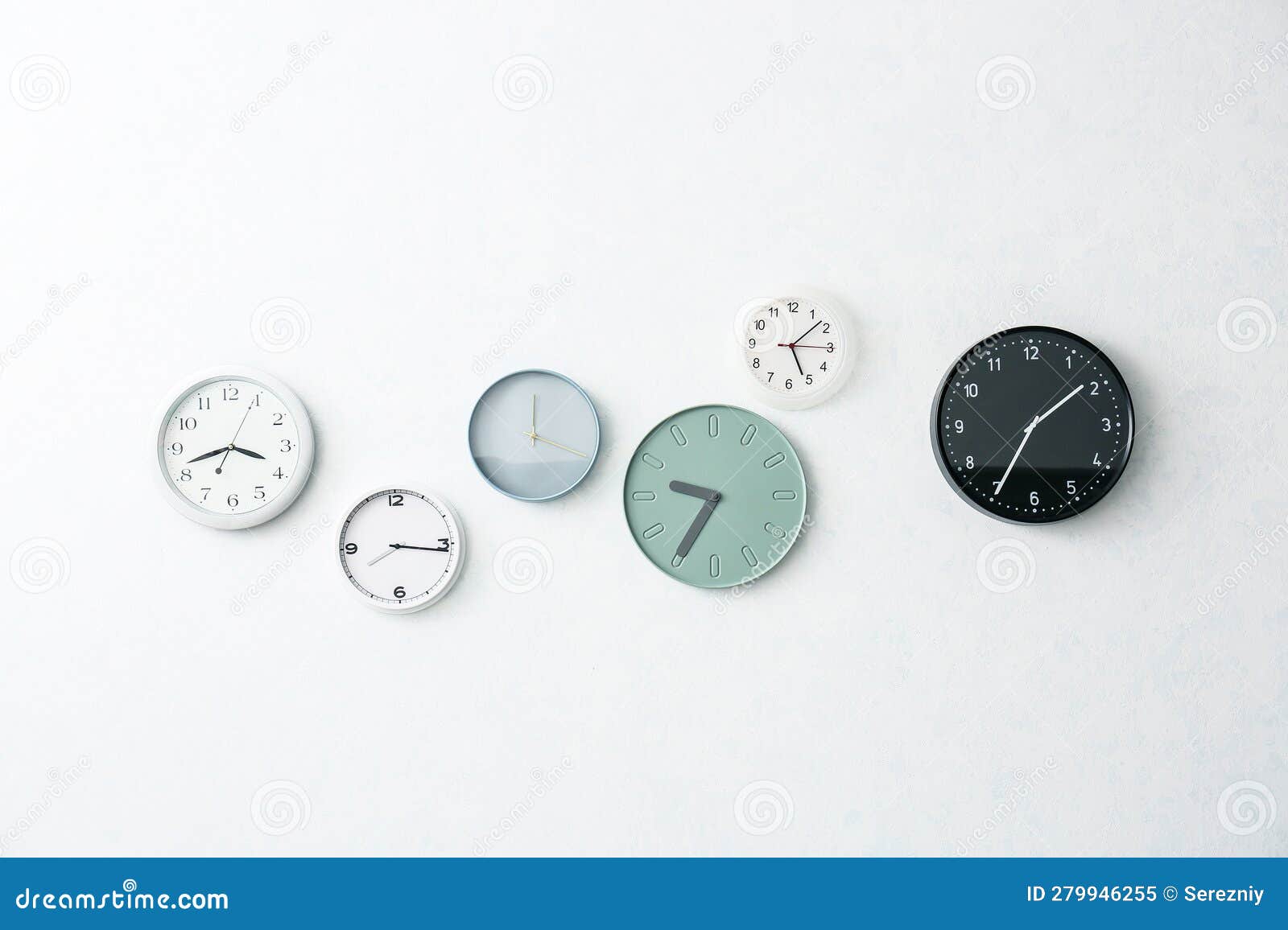 Different Stylish Clocks Hanging on Light Wall Stock Image - Image of ...