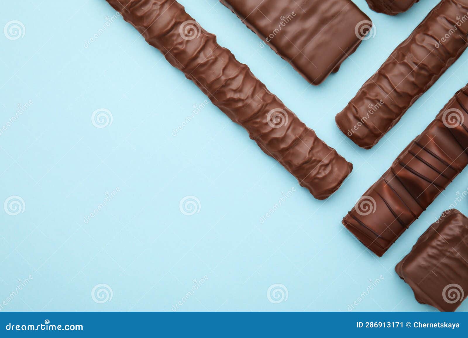Different Tasty Chocolate Bars on Light Blue Background, Flat Lay ...