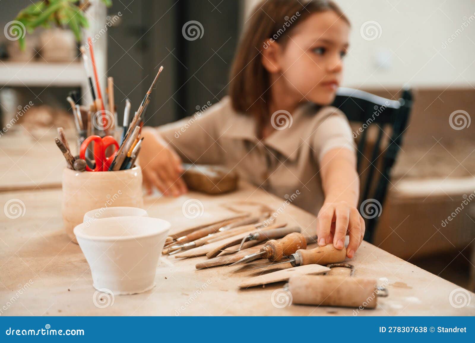 Different Tools on the Table. Little Girl is Learning How To Do Pottery ...