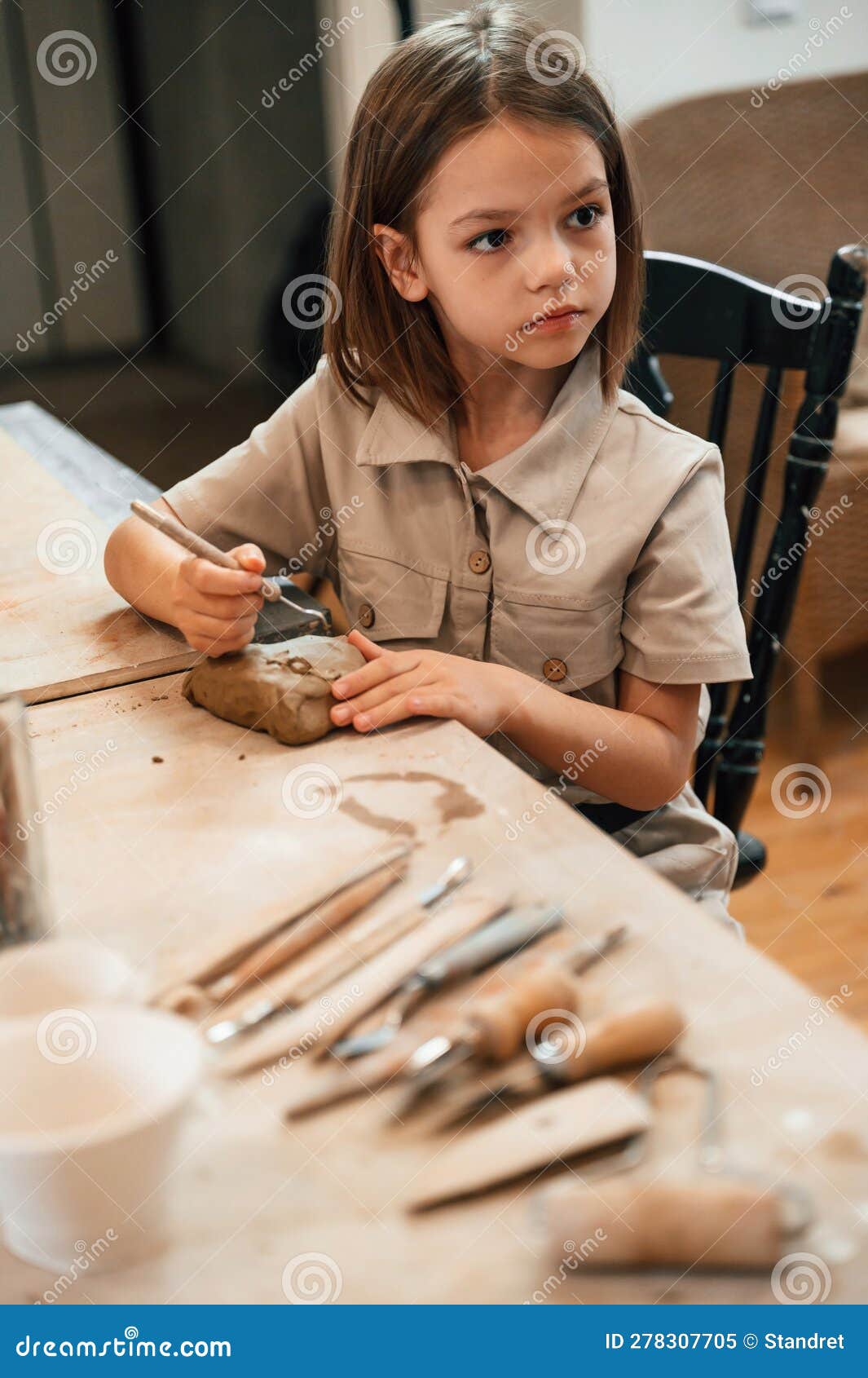 Different Tools on the Table. Little Girl is Learning How To Do Pottery ...
