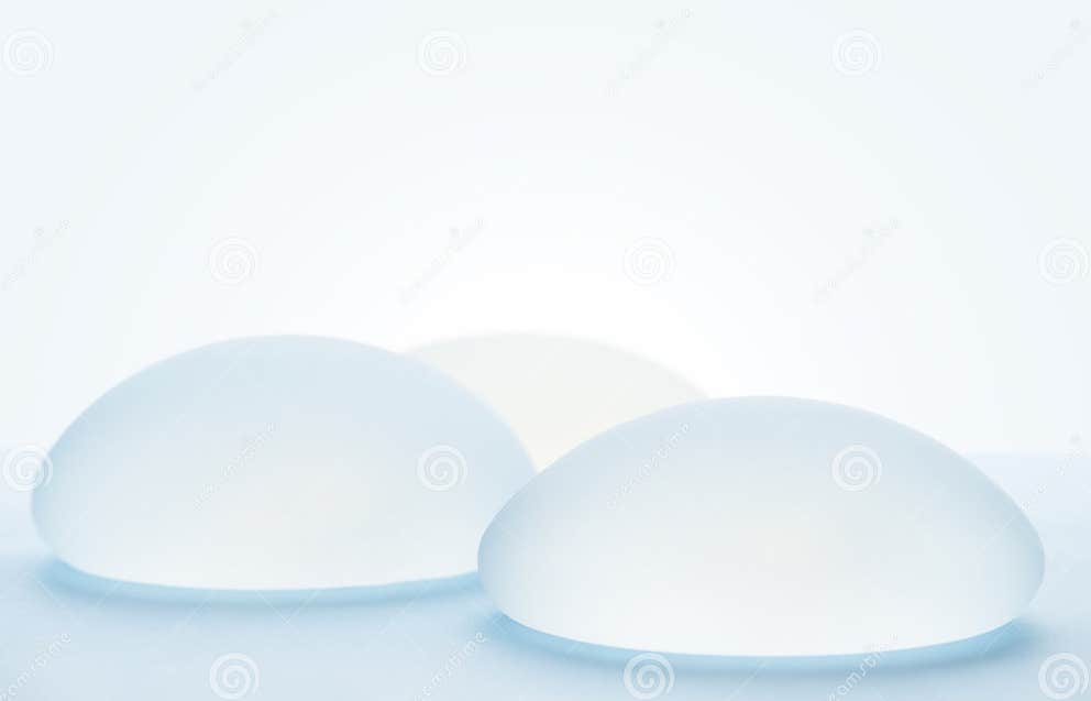 Different Types of Breast Implants on Blue Background. Copy Space Stock ...