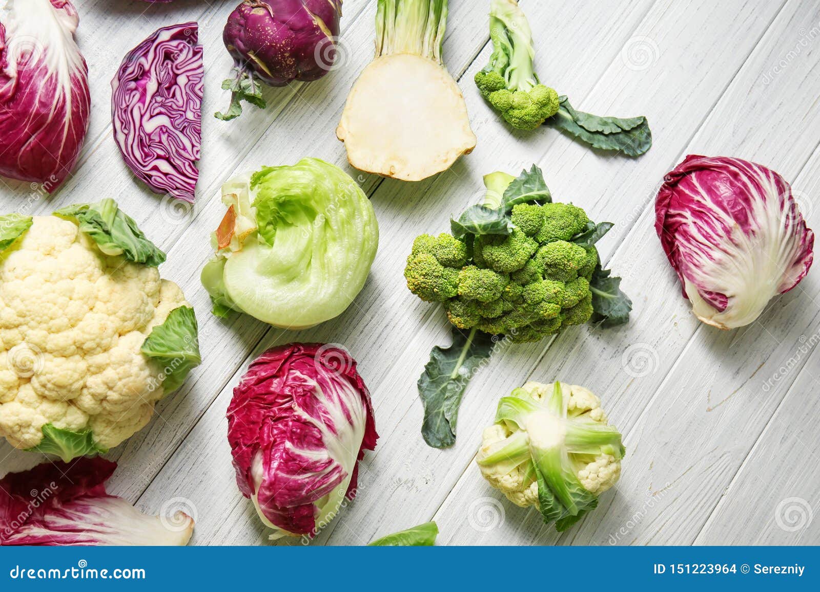 Different Types of Cabbage on Light Wooden Background Stock Photo ...