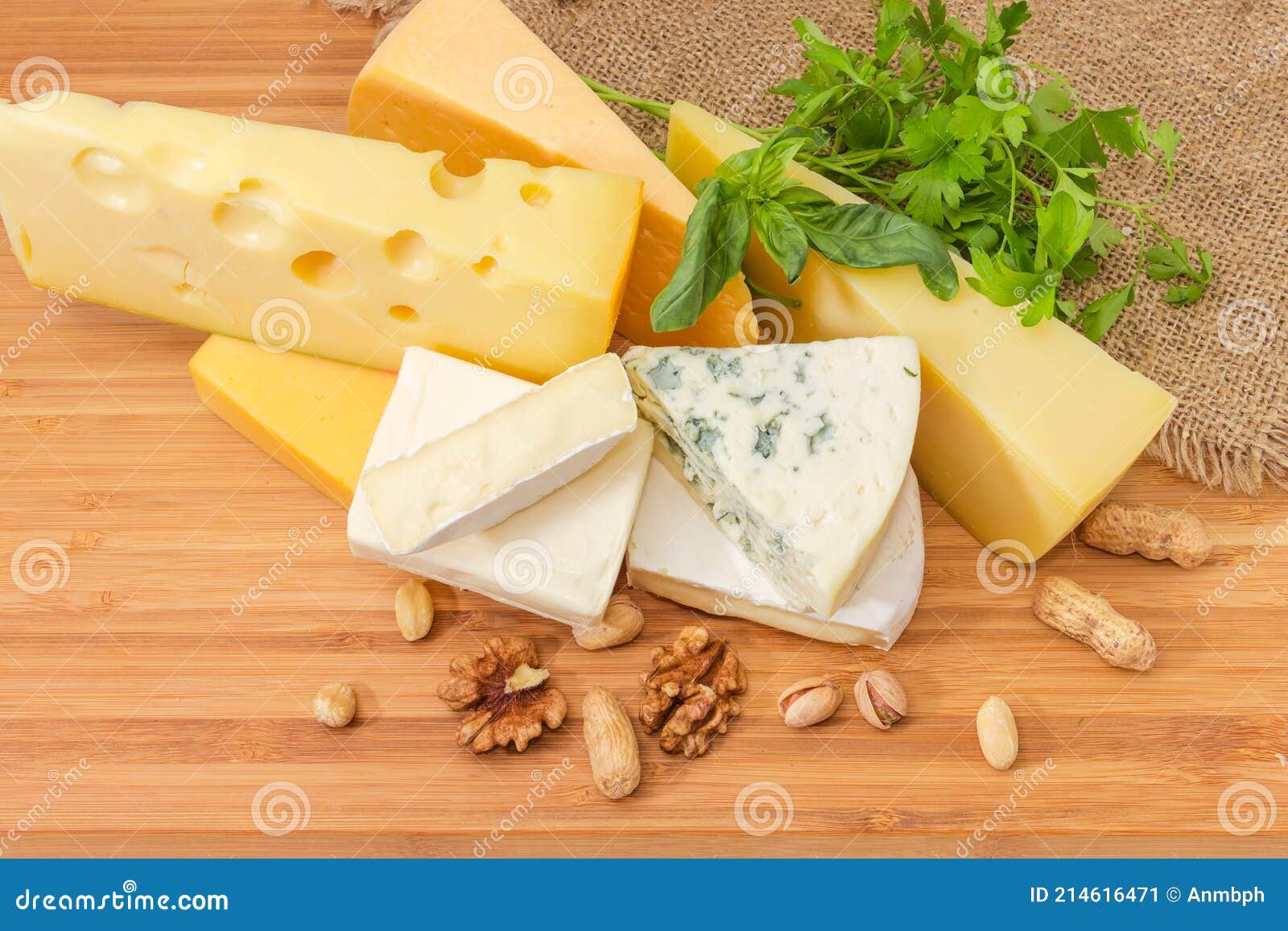 Different Types Cheese with Greens and Nuts on Wooden Surface Stock ...