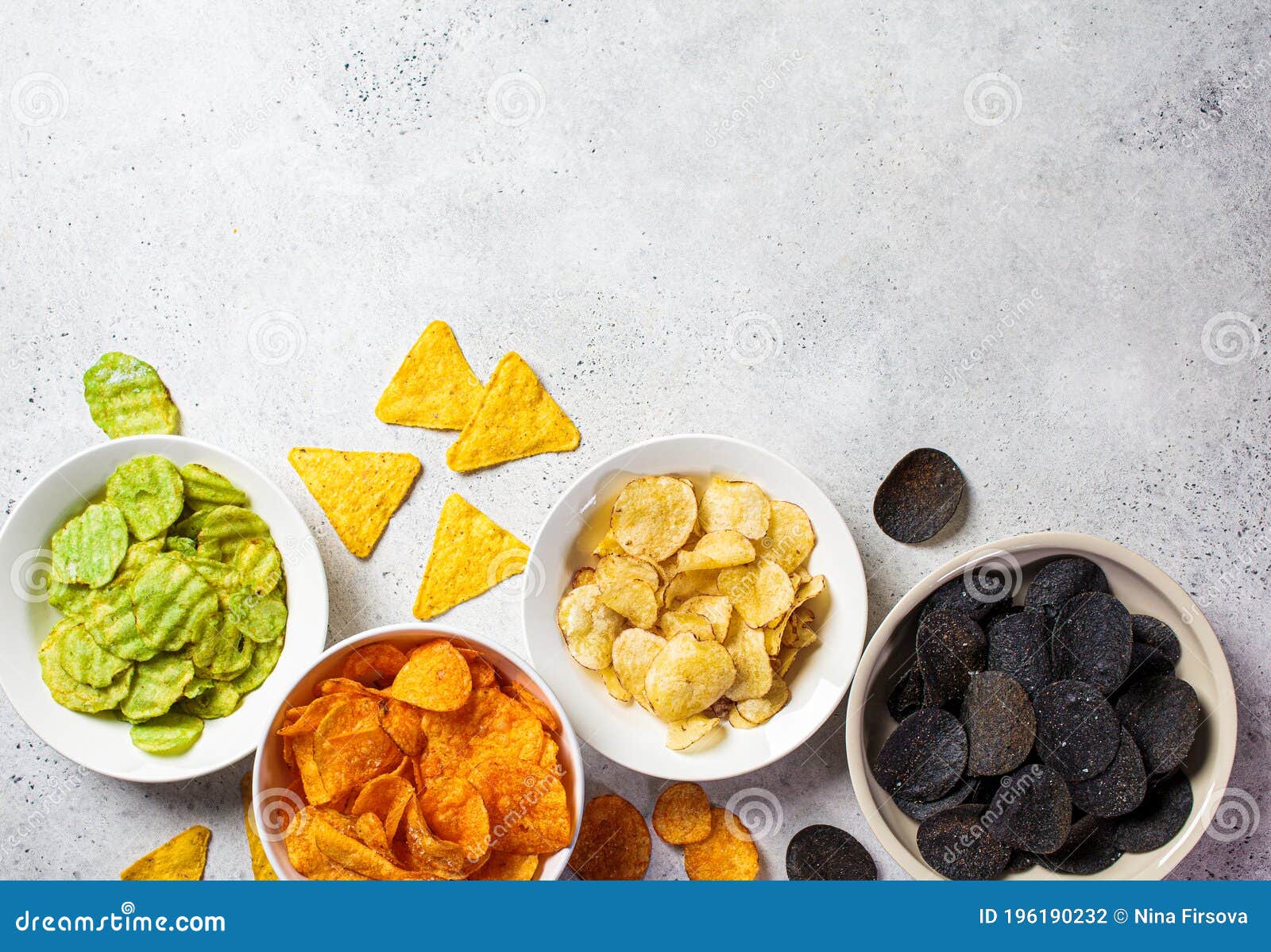Different Types of Colored Potato Chips in White Bowls, Gray Background ...