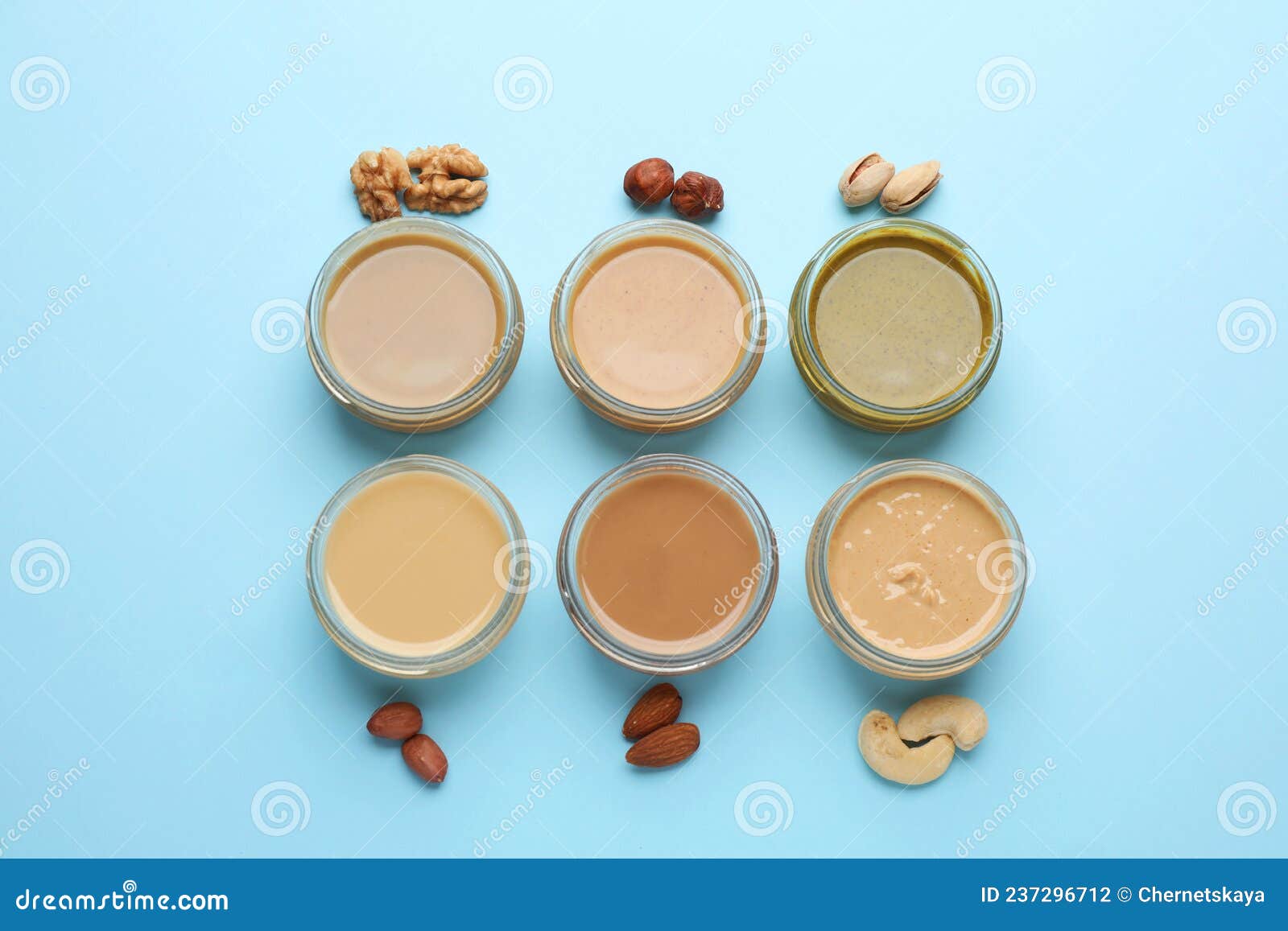 Different Types of Delicious Nut Butters and Ingredients on Light Blue ...