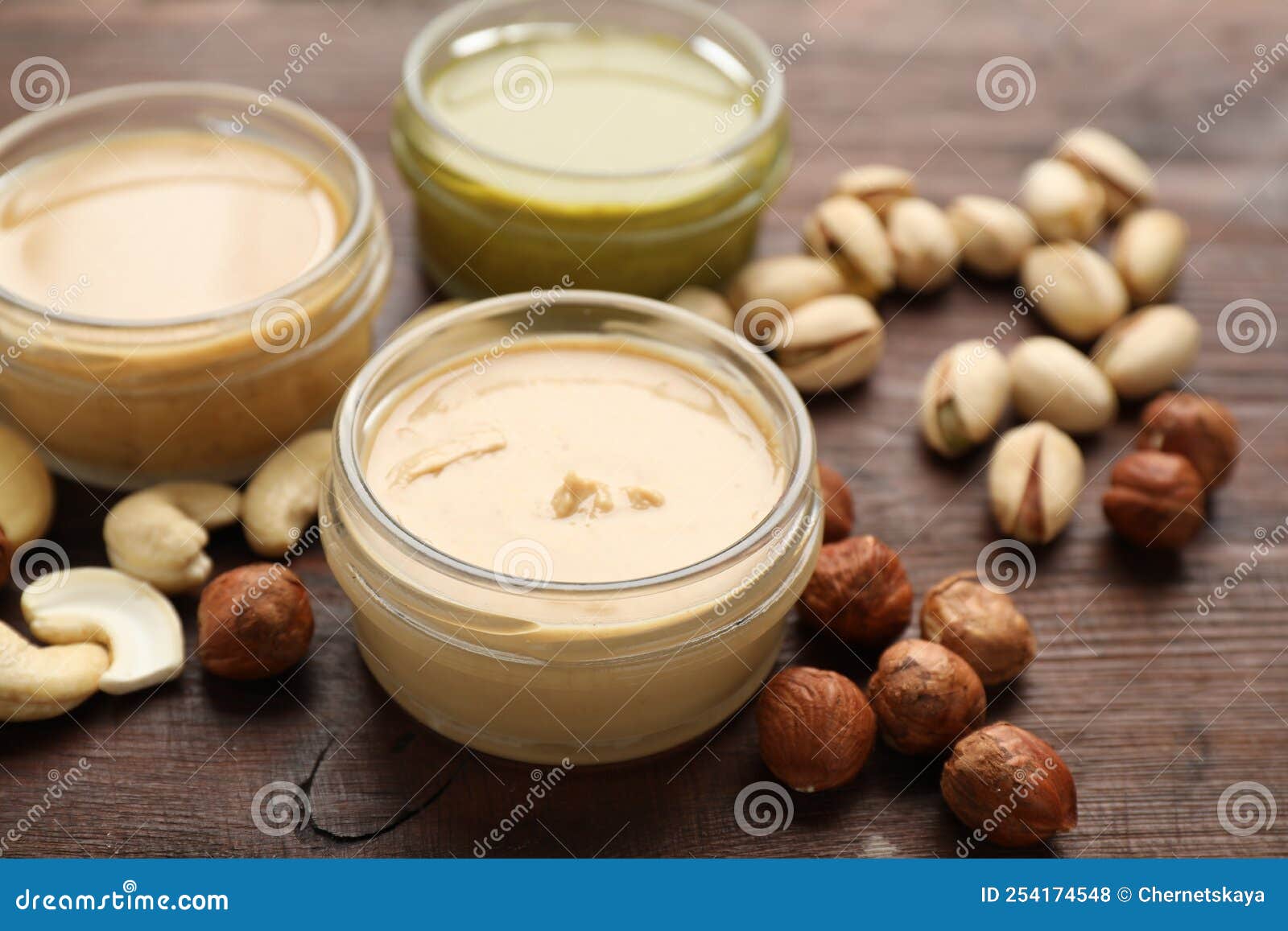 Different Types of Delicious Nut Butters and Ingredients on Wooden ...