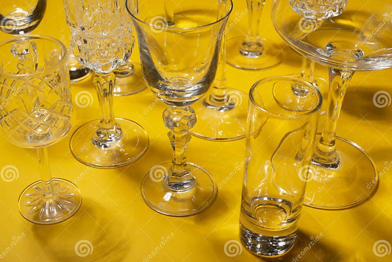 Different Types of Empty Glasses on Yellow Background Stock Photo ...